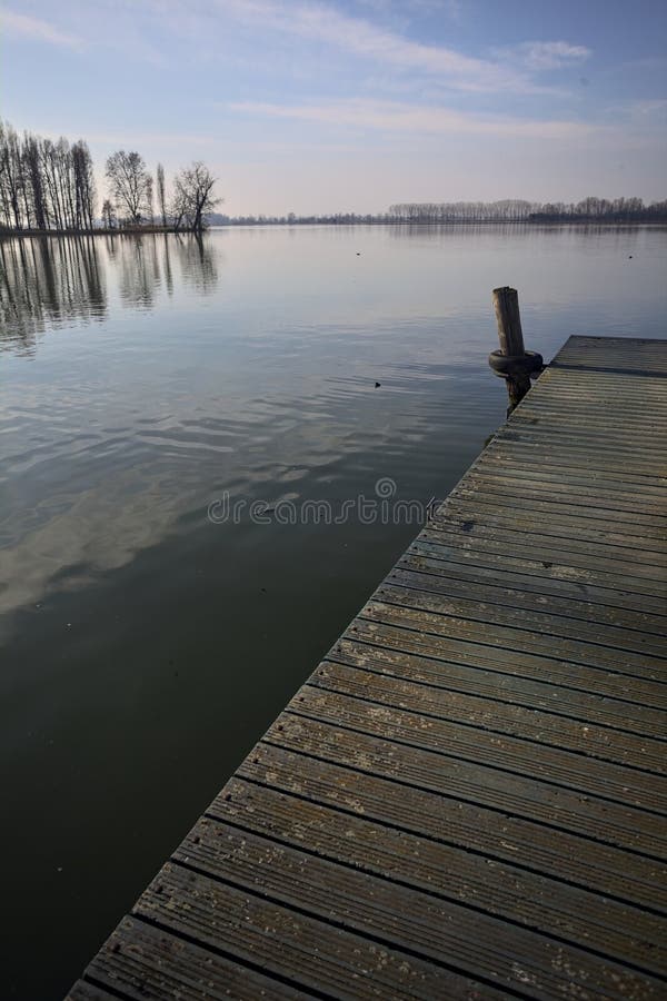 Quay on a river at sunset stock image. Image of dusk - 314217679