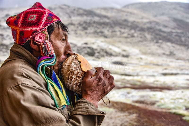 A Quechua Man Blows on a Pututu Conch Shell in the Andes Mountains Near ...