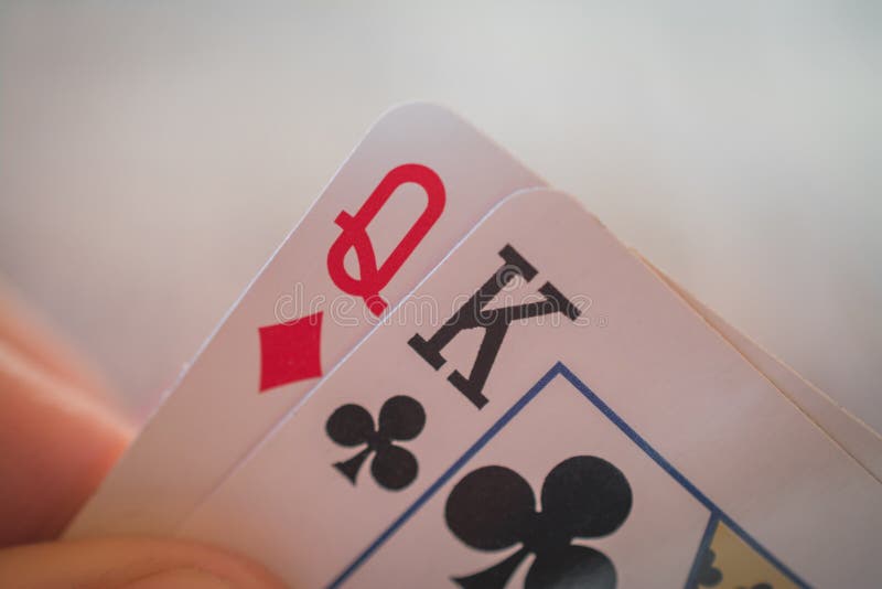 Queen and King, Playing Cards in Hand on the Table, Poker Nands Stock ...