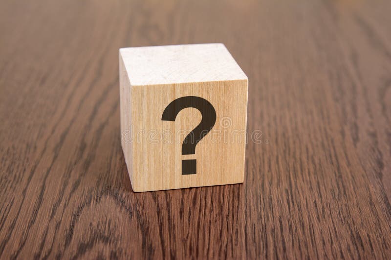 Question Mark Drawn on a Wooden Cube with Copy Space on a Dark Wooden ...