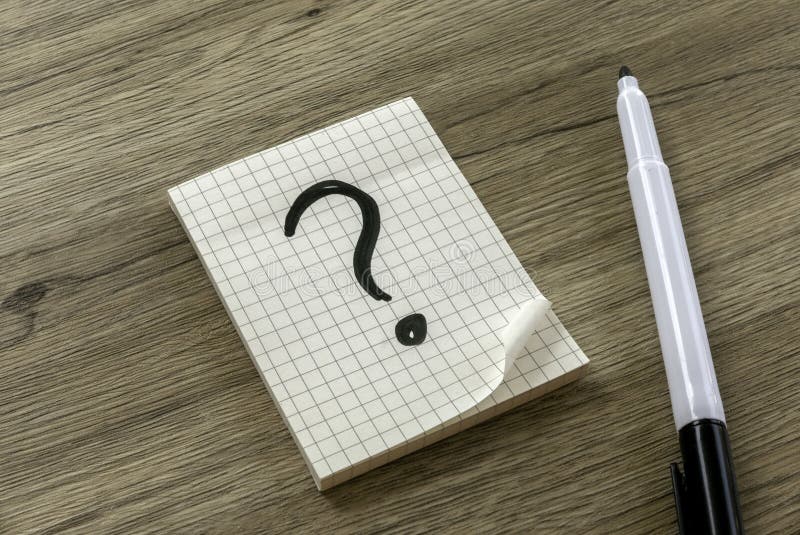 Question Mark on Graph Paper Notepad and Pen on Wooden Surface Stock ...