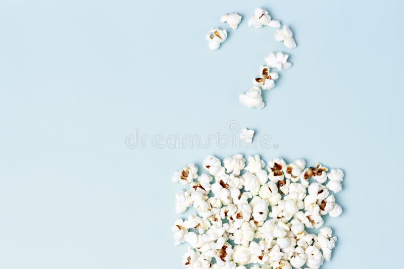 Question Mark Laid Out of Popcorn on a Blue Background Close-up, Top ...