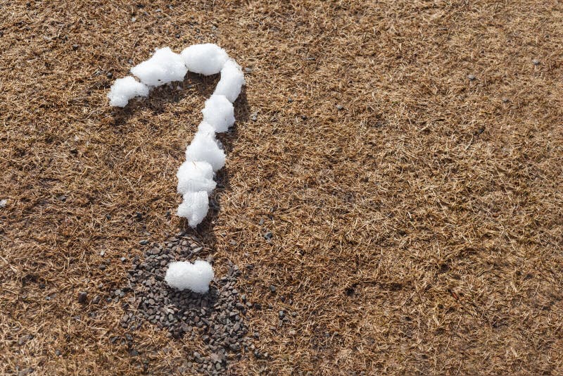 The Question Mark is Lined with Lumps of Snow on Yellow Dry Grass Stock ...