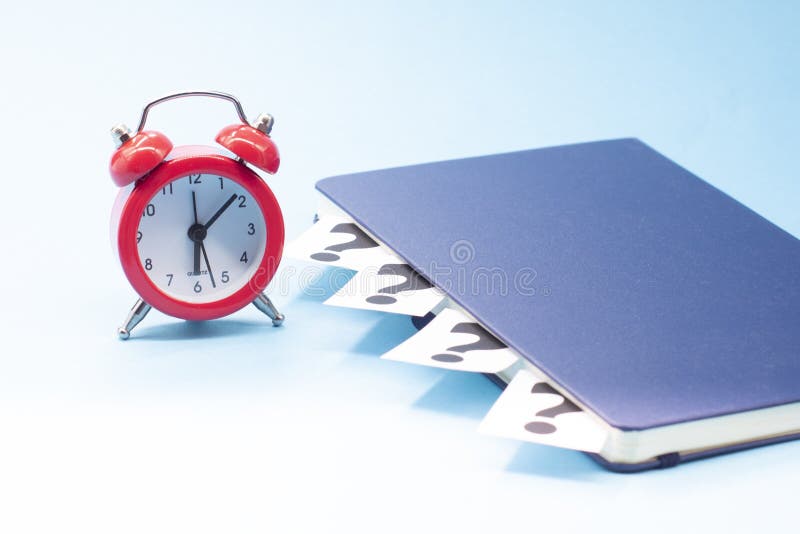 A Question Mark on a White Sheet and a Red Alarm Clock . FAQ Frequency ...