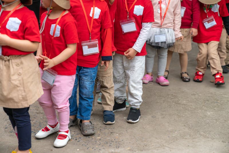 Queue of Asian Kids in School Uniform Standing in Line Stock Photo ...