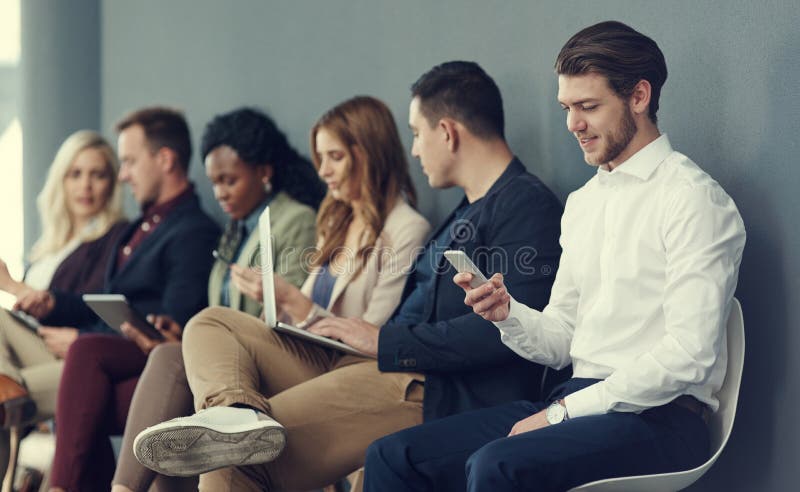 The Queue To Success. Shot of a Group of Businesspeople Using Different ...