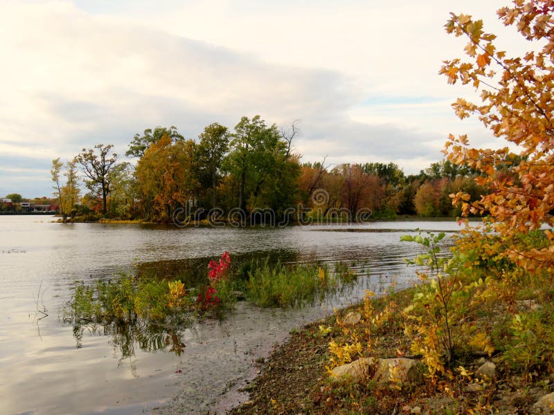 Quiet Bay in Autumn with Colorful Trees and Some Clouds Stock Photo ...
