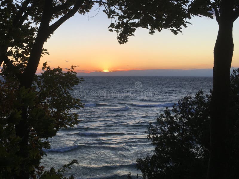 Quiet Lake Michigan sunset stock image. Image of shore - 371321535