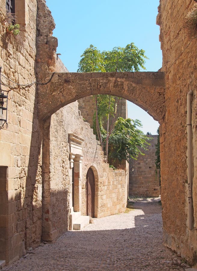 Medieval Cobbled Street in Rhodes Town with Old Buildings and Arches ... Medieval Cobbled Street in Rhodes Town with Old Buildings and Arches ...