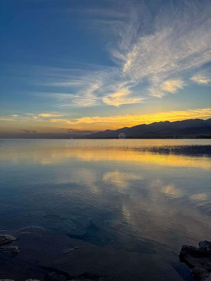 Quiet Mountain Lake, Evening Light on the Water, Kyrgyzstan. Still ...