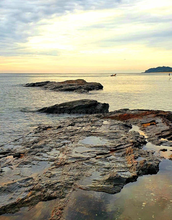 Black Rocks Provide a Nice Backdrop on the Beach during Sunset Stock ...
