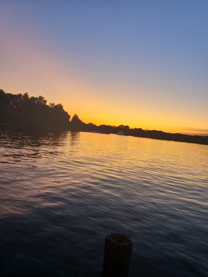 Quiet sunset on the water stock photo. Image of sunset - 161562938