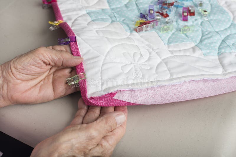 Adding Plastic Edge Clips To a Quilt Stock Photo - Image of color ...