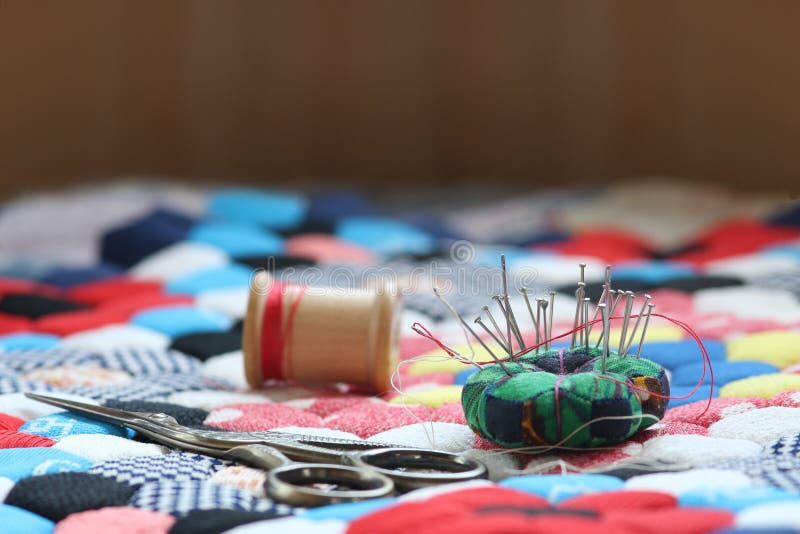 Quilting Supplies on a Colorful Hexagon Mosaic Patterned Quilt Stock ...