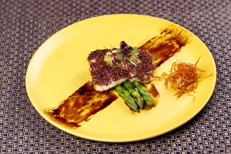 Quinoa Crusted Fish on Asparagus on Yellow Plate. Stock Photo - Image ...