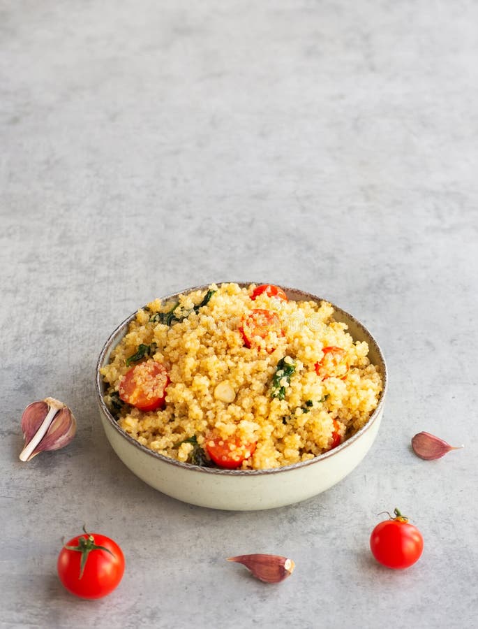 Quinoa with Tomatoes, Spinach and Garlic Stock Photo - Image of lunch ...