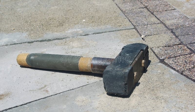 A Quite Worn-out Rubber Paving Hammer Lying on a Freshly Paved Surface ...