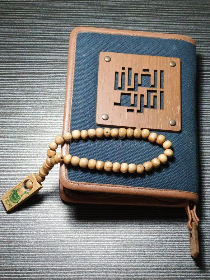 A Quran and Prayer Beads & X28;tasbih& X29; on the Table with a ...