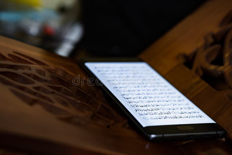 Quran in Smart Phone Apps on Wooden Book Stand Editorial Photo - Image ...