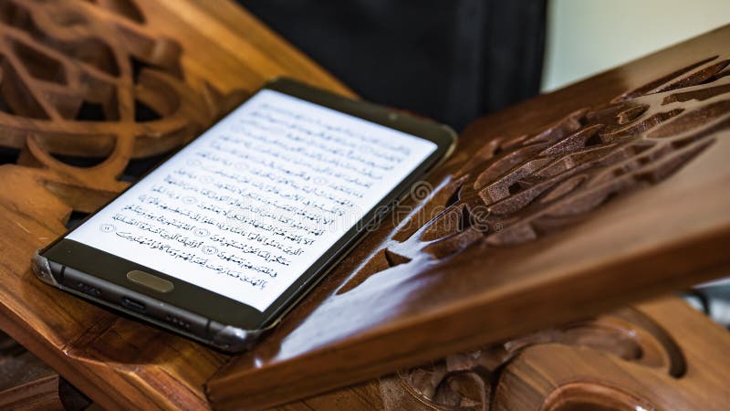 Quran in Smart Phone Apps on Wooden Book Stand Editorial Photo - Image ...