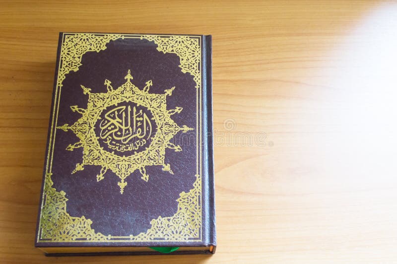 Quran on the wooden table stock photo. Image of light - 43511888
