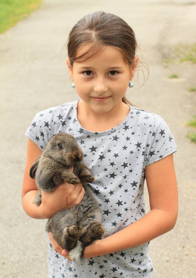 Rabbit in kids hands stock image. Image of child, hand - 32848095