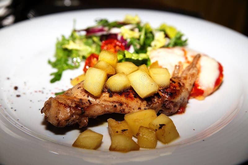 Rabbit Leg with Apple Confit and Vegetable Salad Stock Photo - Image of ...