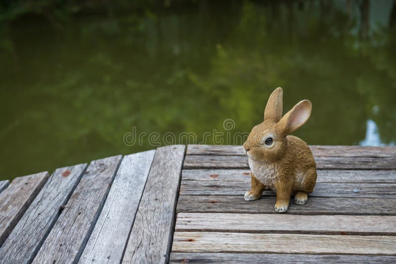 Rabbit Model Decor at Wooden Bridge by Pond with Tree Reflection Stock ...