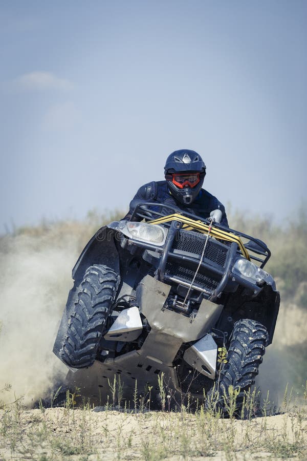 Riding ATV in sand dunes stock image. Image of angle - 17256419