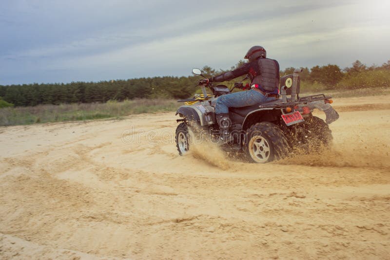 Racing ATV is sand. stock image. Image of people, quad - 70656125