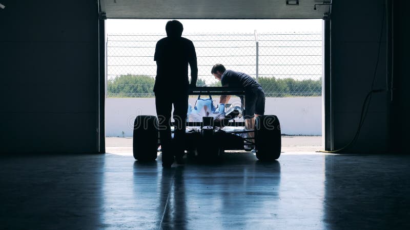 Racing Car is Getting Wheeled into the Workshop Stock Video - Video of ...