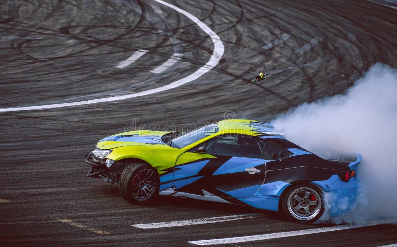 A Racing Drift Car Skids while Moving on a Turn on a High-speed Track ...