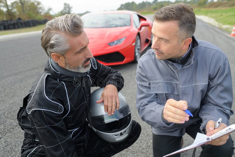 Racing Driver Talking with Coach Stock Photo - Image of senior ...