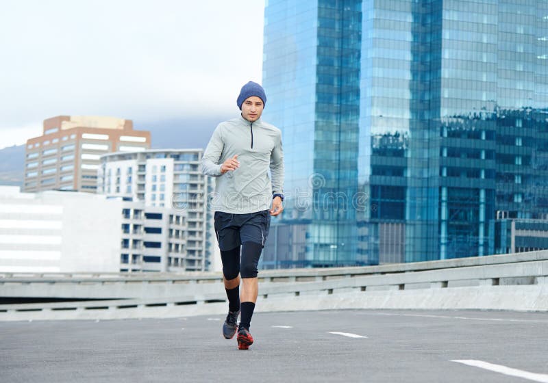 Racing through the Empty Streets. a Young Man Jogging through Empty ...