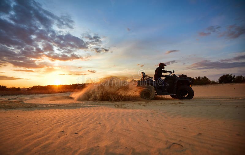 Racing in the Sand on a Four-wheel Drive Quad Stock Image - Image of ...