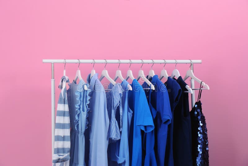 Rack with bright clothes stock image. Image of outfit - 128984323
