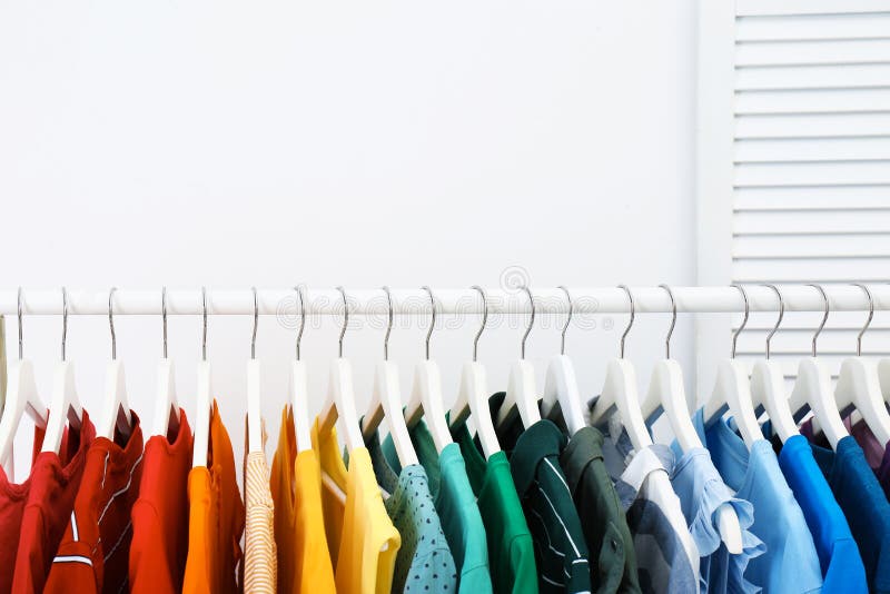 Rack with Bright Clothes in Room Stock Photo - Image of room, color ...