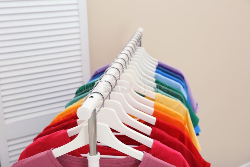 Rack with Bright Clothes in Room Stock Photo - Image of garment ...