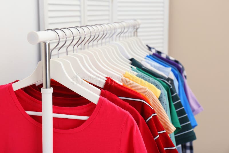 Rack with Bright Clothes in Room Stock Photo - Image of clean, colors ...