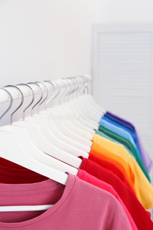 Rack with Bright Clothes in Room. Stock Image - Image of rainbow, light ...