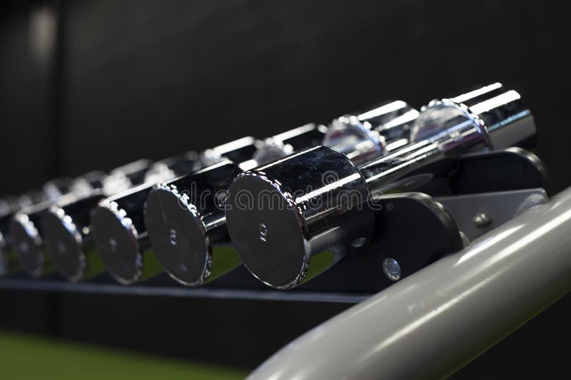 Rack with chrome dumbbells stock photo. Image of body - 279780700