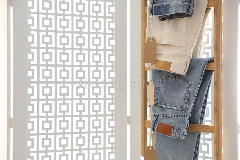 Rack with Different New Jeans in Showroom. Space for Text Stock Photo ...