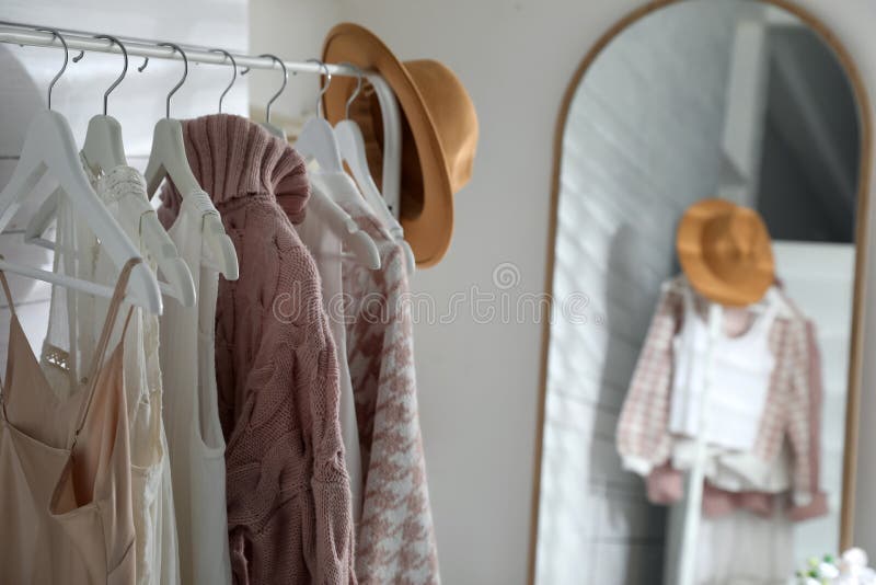 Rack with Different Stylish Clothes and Hat Near Mirror in Dressing ...