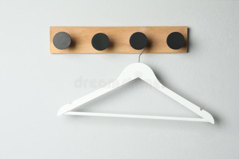 Rack with Empty Clothes Hanger on White Wall Stock Photo - Image of ...