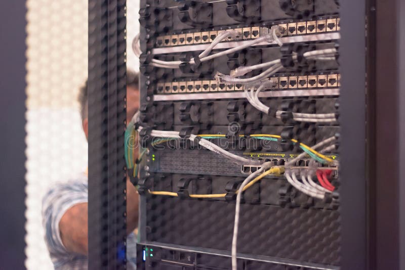 Rack Mounted Servers in a Server Room, Man Work with Lan or Network ...