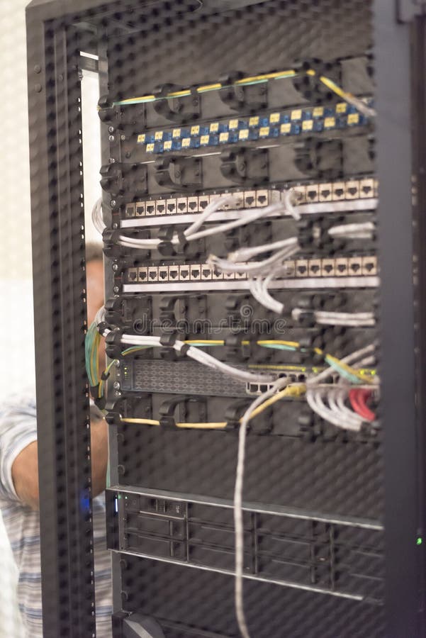 Rack Mounted Servers in a Server Room, Man Work with Lan or Network ...