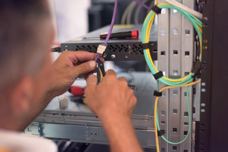 Rack Mounted Servers in a Server Room, Man Work with Lan or Network ...