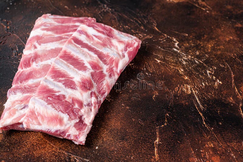 Rack of Raw Pork Spare Ribs on Butcher Table. Dark Background. Top View ...