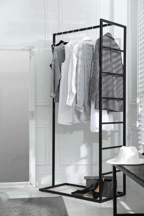 Rack with Stylish Women`s Clothes and Large Mirror in Dressing Room ...