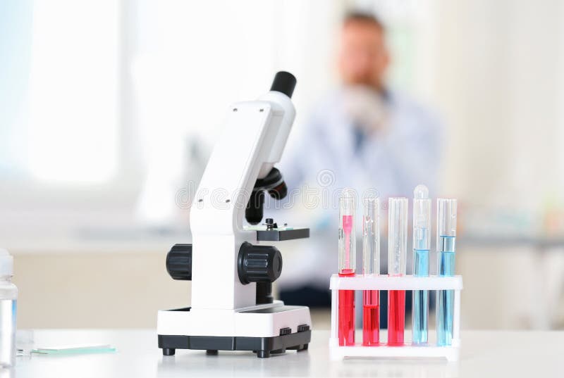 Rack with Test Tubes and Microscope on Table in Laboratory Stock Photo ...